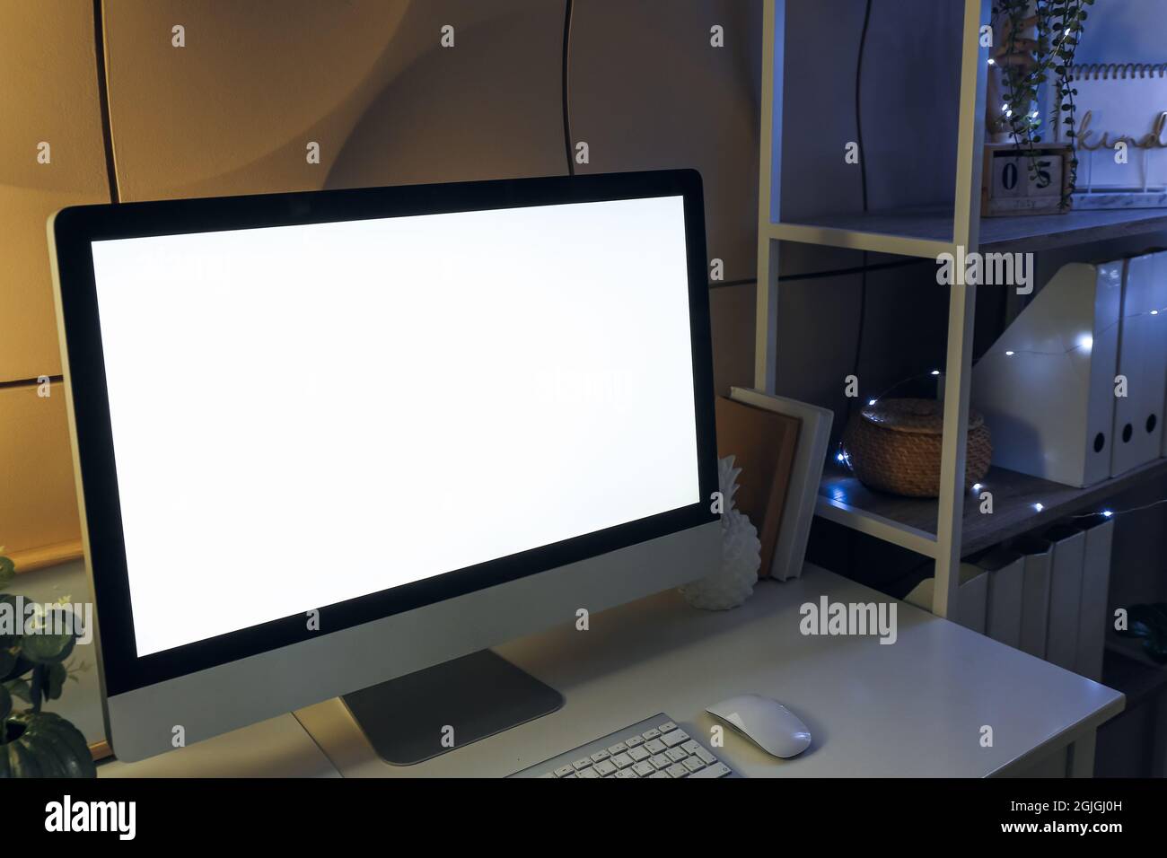 Modern workplace with computer in dark room Stock Photo - Alamy