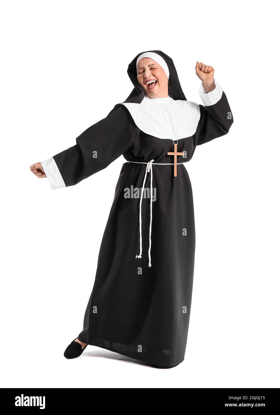 Happy mature nun dancing on white background Stock Photo - Alamy