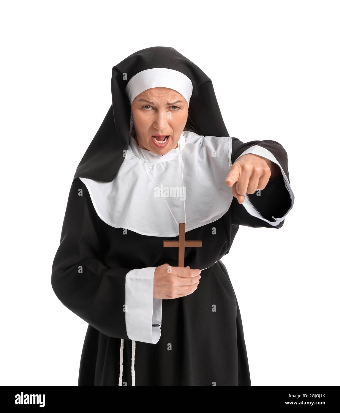 Mature nun pointing at viewer on white background Stock Photo - Alamy