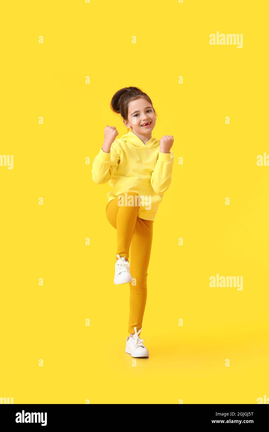 Happy little girl on color background Stock Photo - Alamy