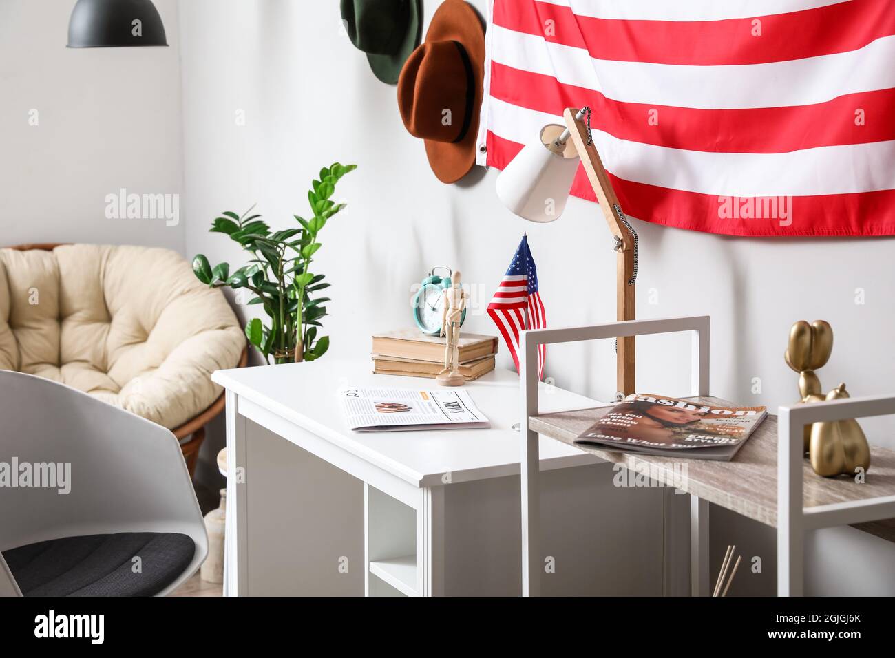 Modern workplace with USA flags near light wall Stock Photo - Alamy