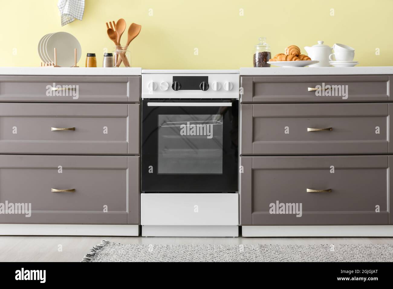 Modern counter with oven near color wall in kitchen Stock Photo - Alamy
