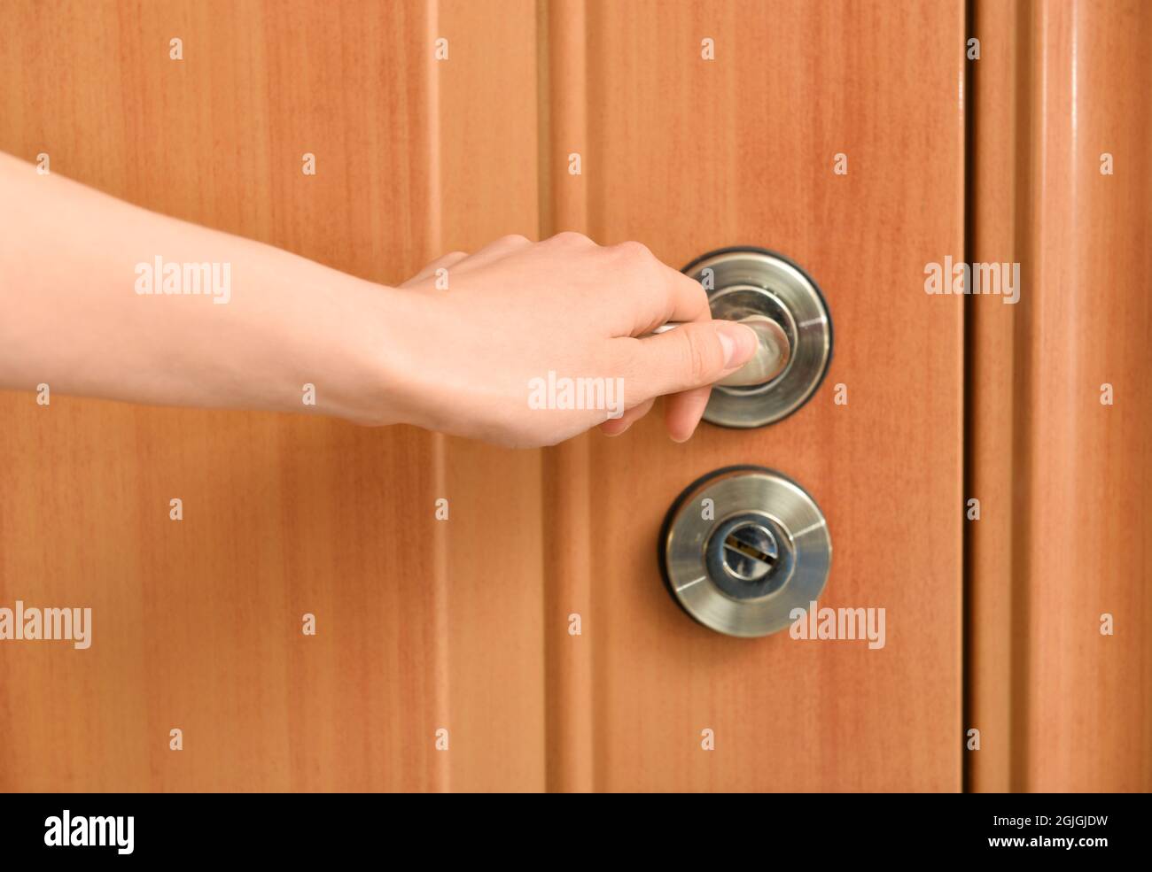 Female hand opening brown door hi-res stock photography and images - Alamy