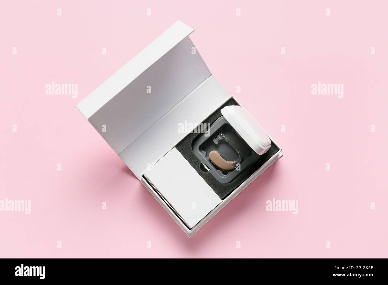 Box with hearing aid on color background Stock Photo - Alamy