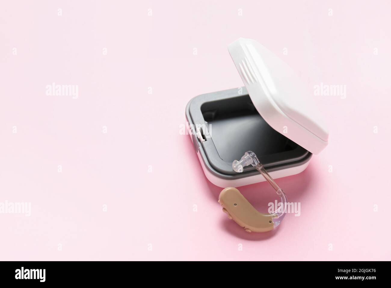 Box with hearing aid on color background Stock Photo - Alamy