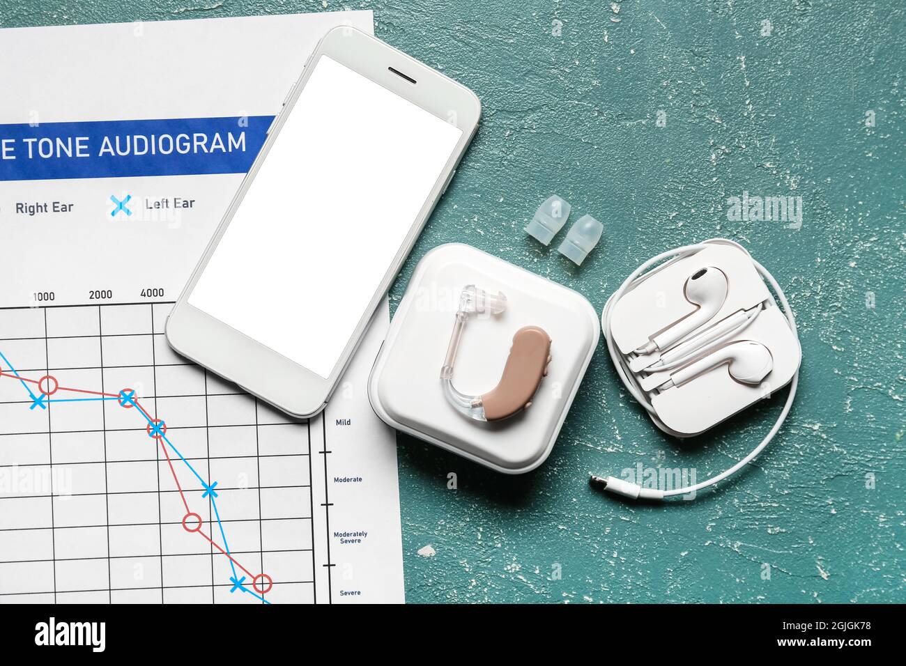 Audiogram with hearing aid and gadgets on color background Stock Photo ...