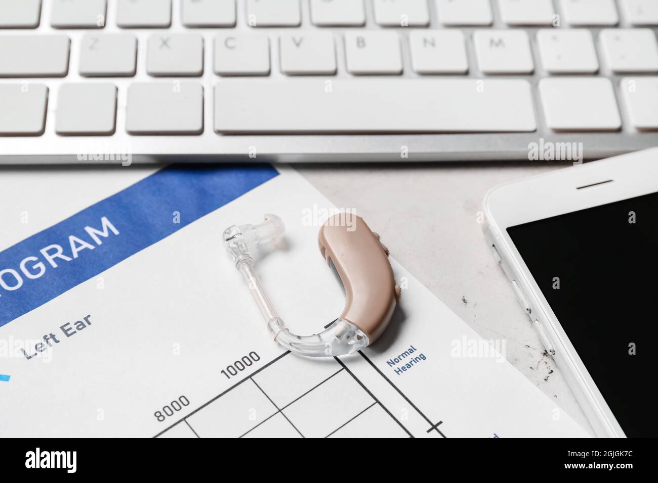 Audiogram with hearing aid, mobile phone and computer keyboard on white ...