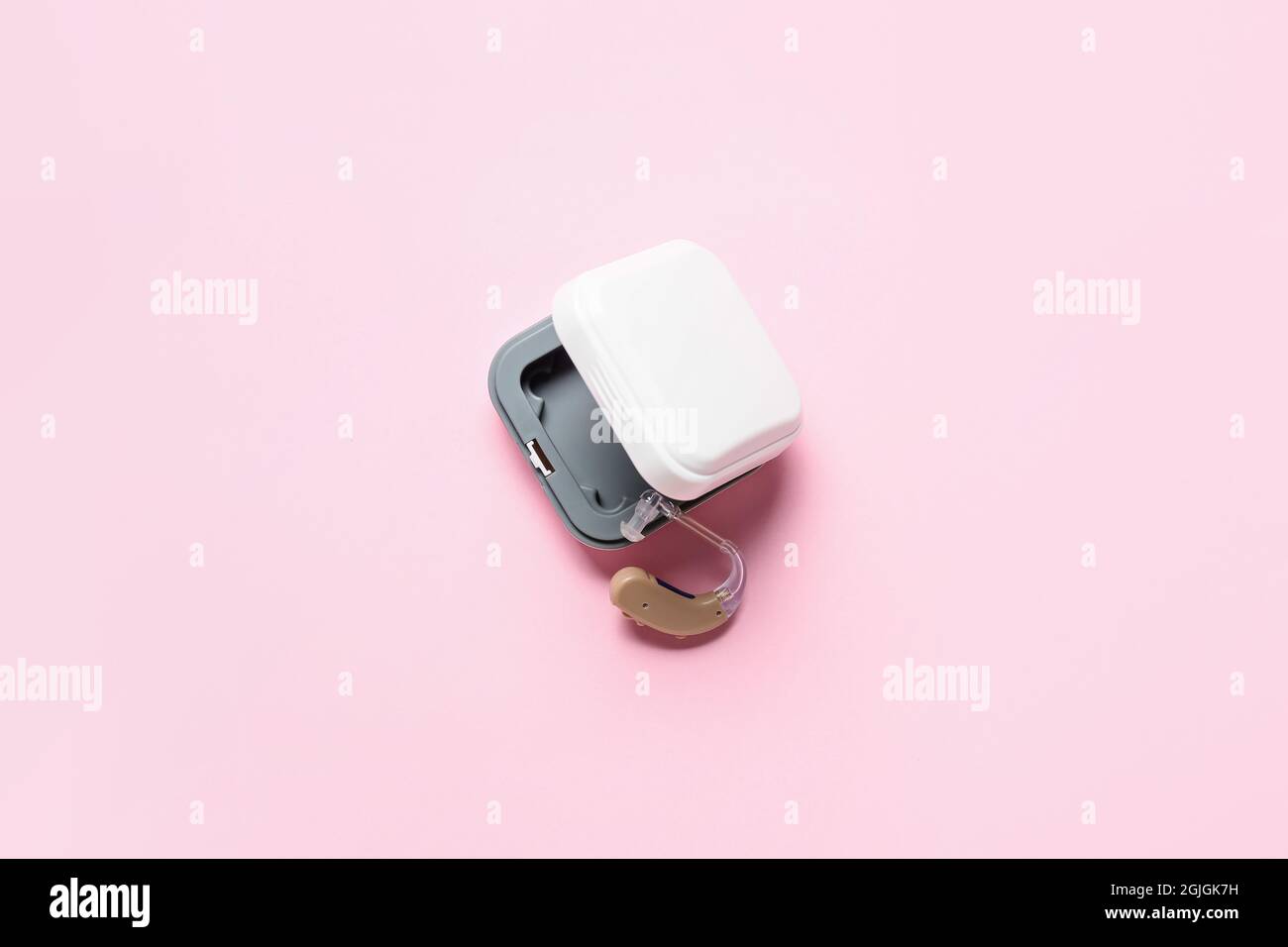 Box with hearing aid on color background Stock Photo - Alamy