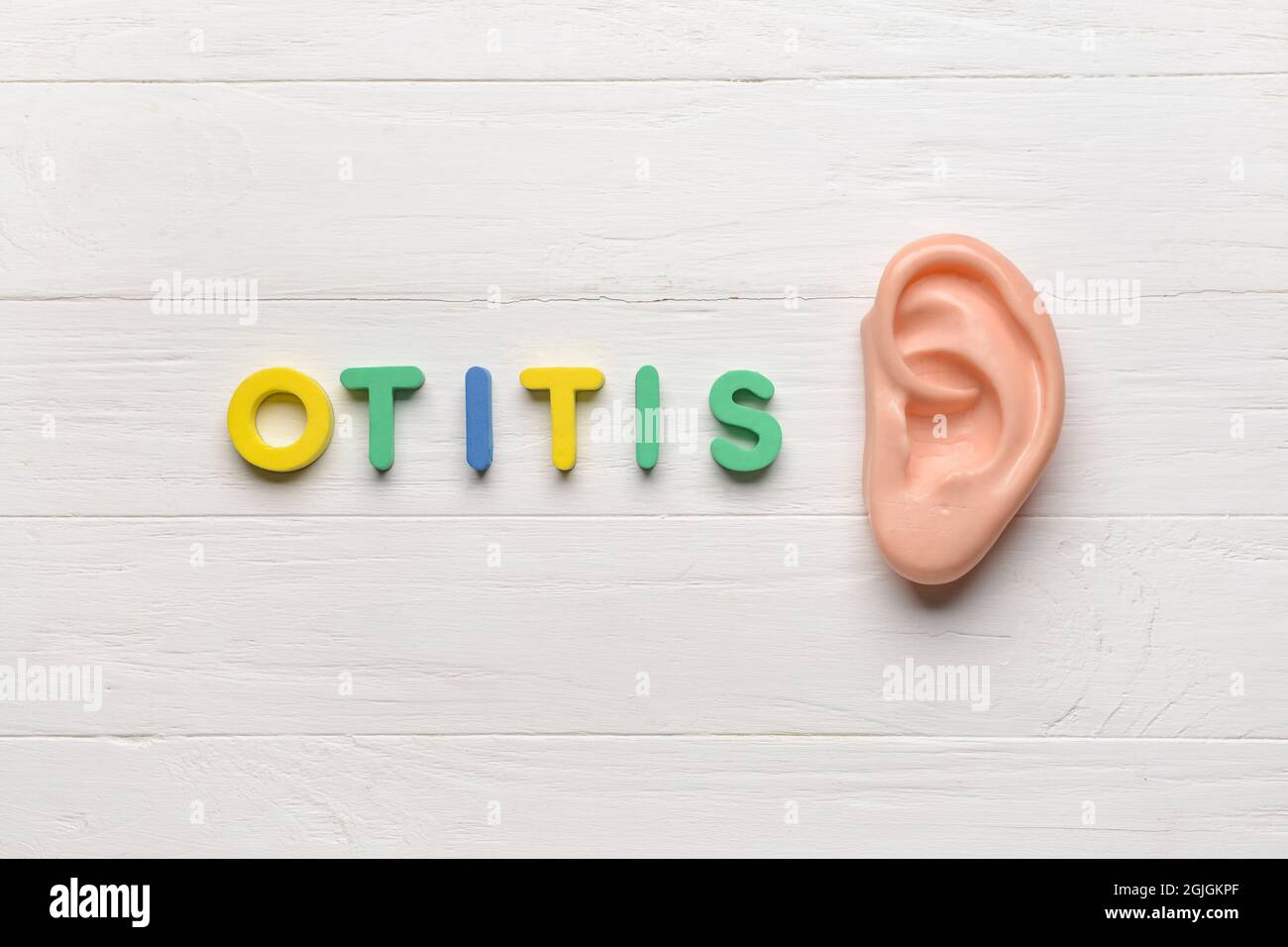 Word OTITIS and ear model on white wooden background Stock Photo - Alamy
