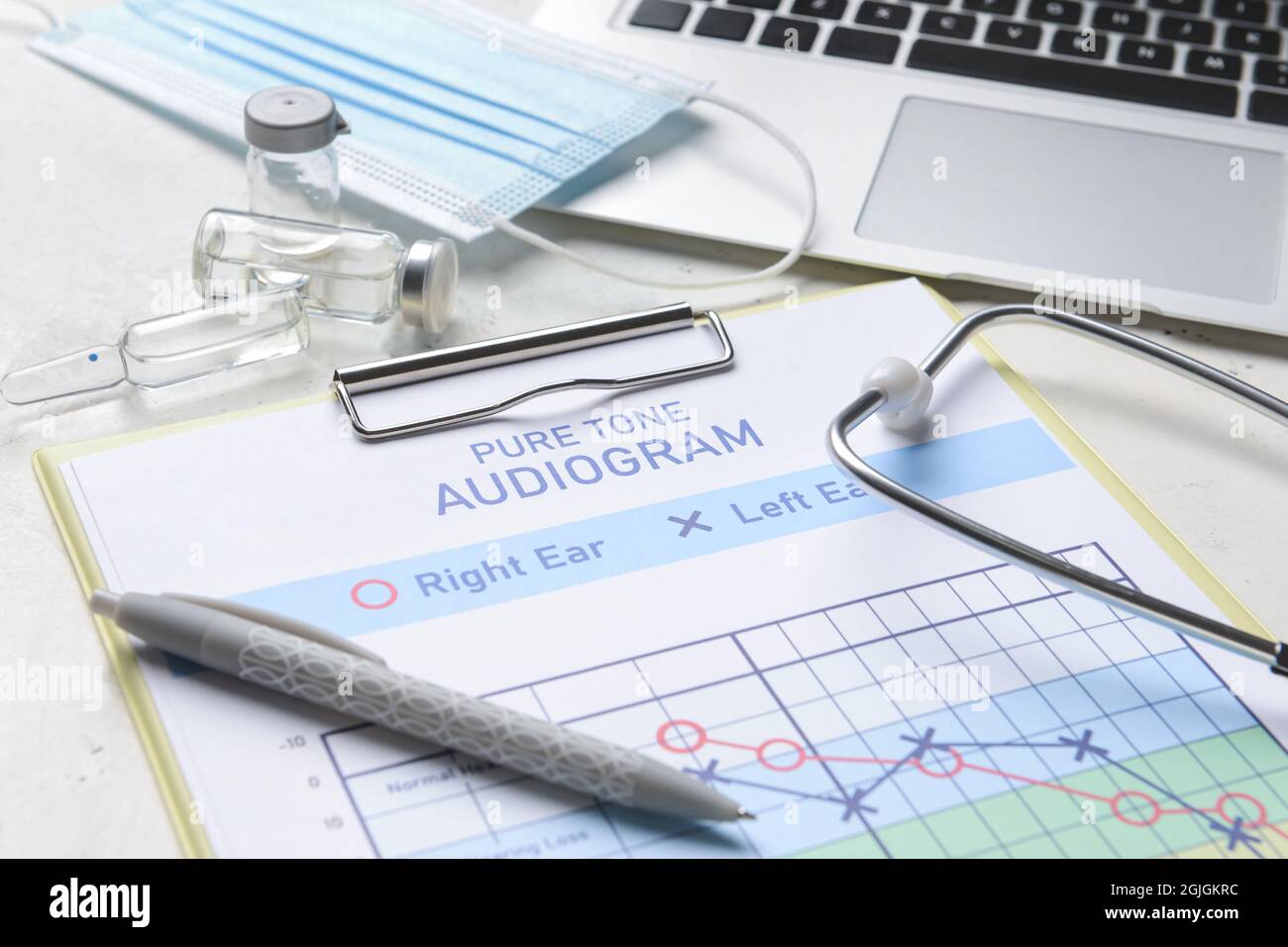 Audiogram with stethoscope and medical mask on white background ...
