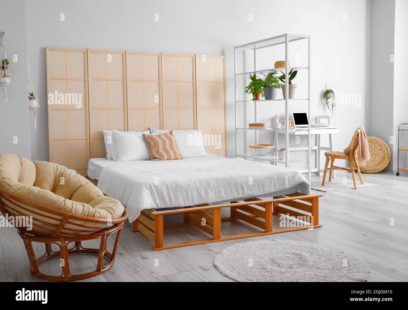 Interior of stylish bedroom with folding screen Stock Photo - Alamy