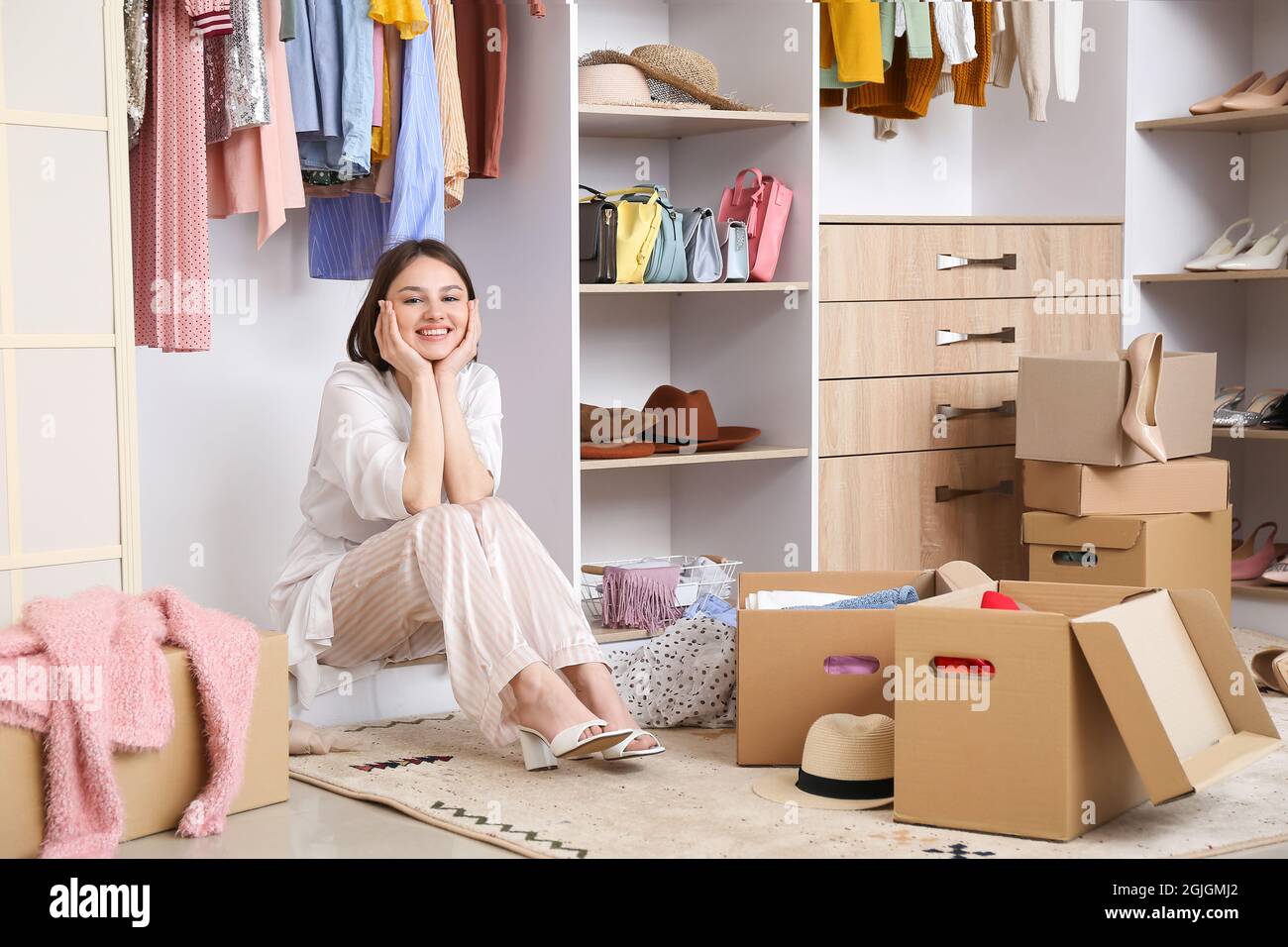 Woman arranging closet hi-res stock photography and images - Alamy