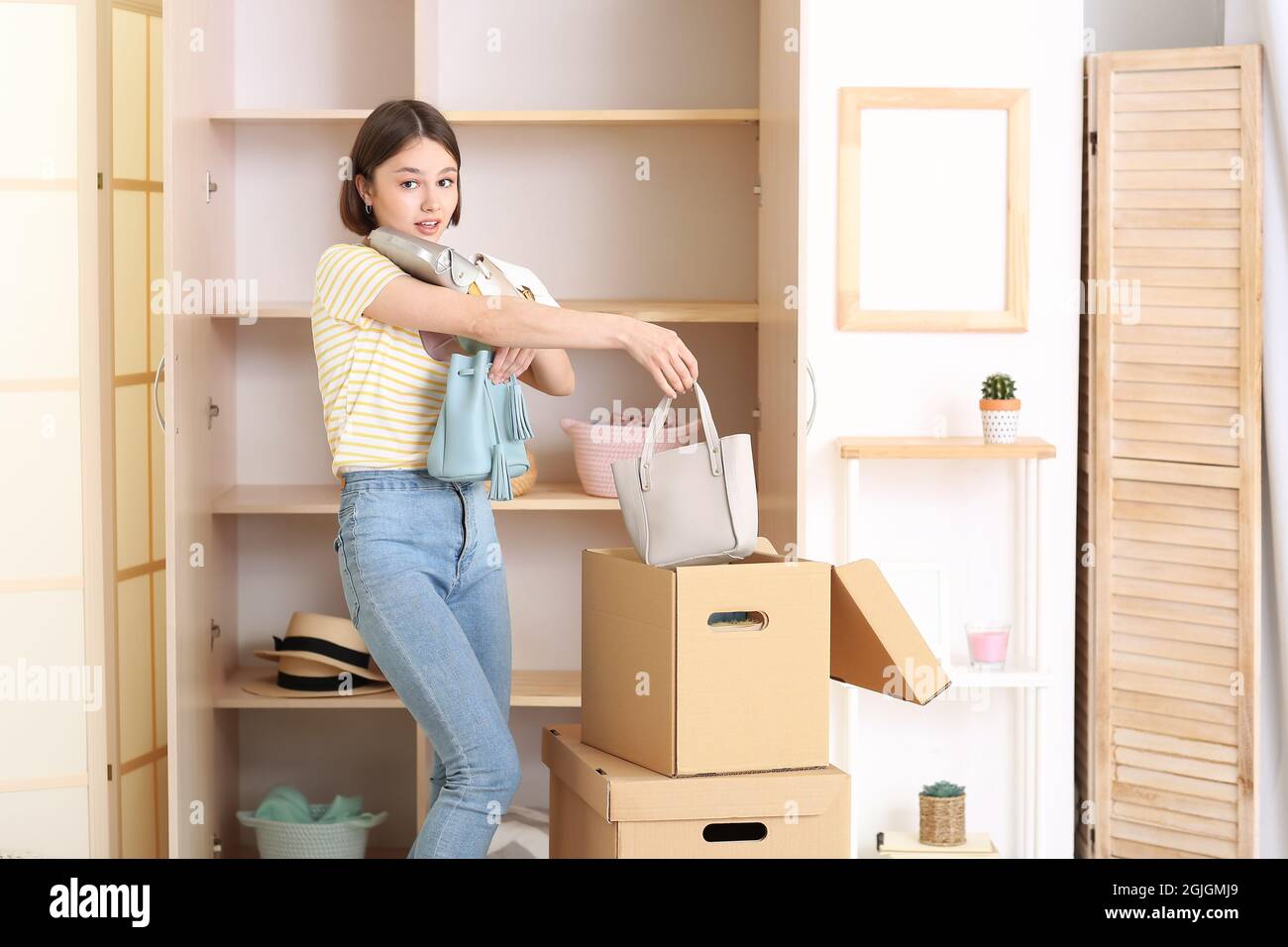 Woman arranging closet hi-res stock photography and images - Alamy