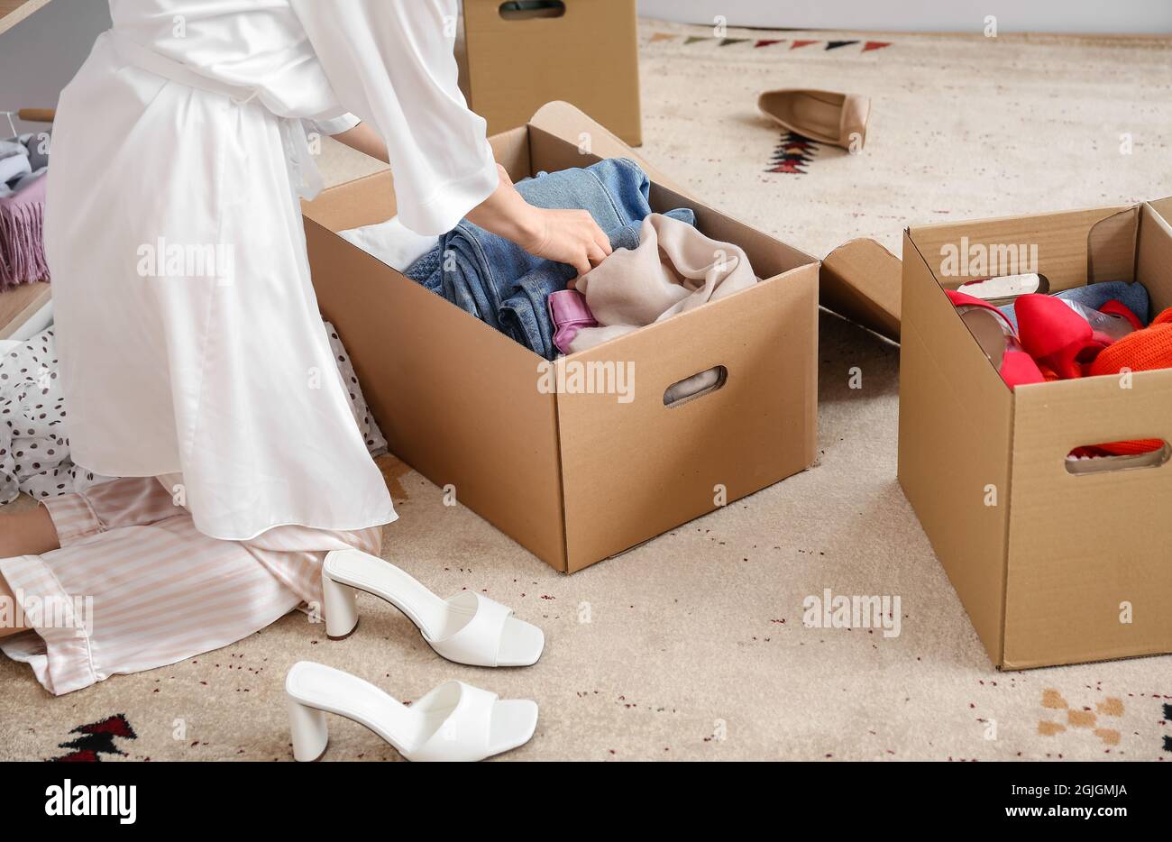 Woman arranging closet hi-res stock photography and images - Alamy