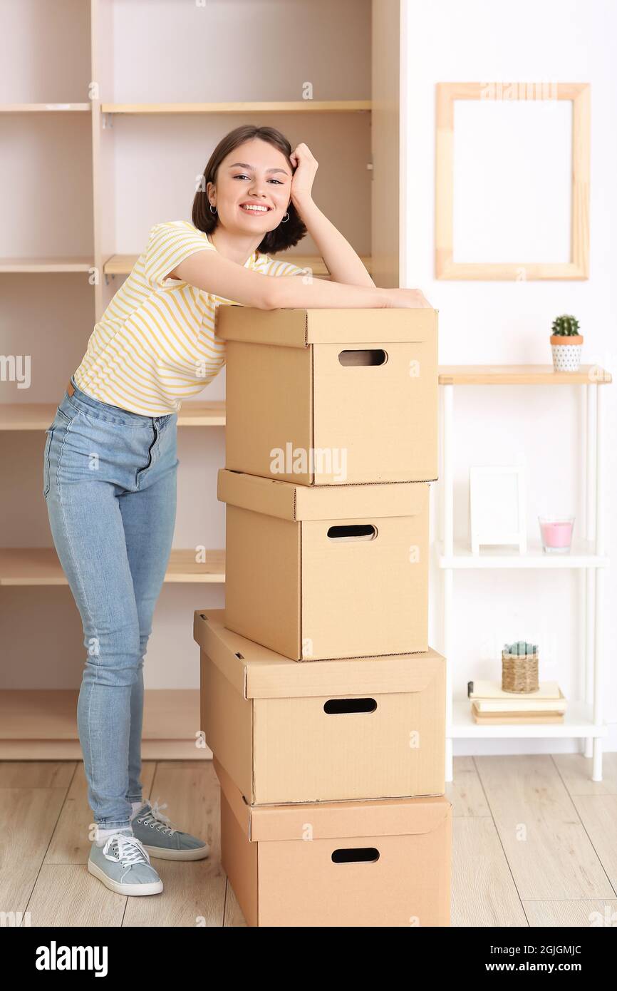 Young woman with wardrobe boxes at home Stock Photo - Alamy