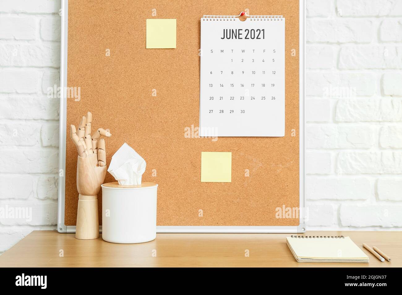 Modern workplace with sticker board near brick wall Stock Photo - Alamy