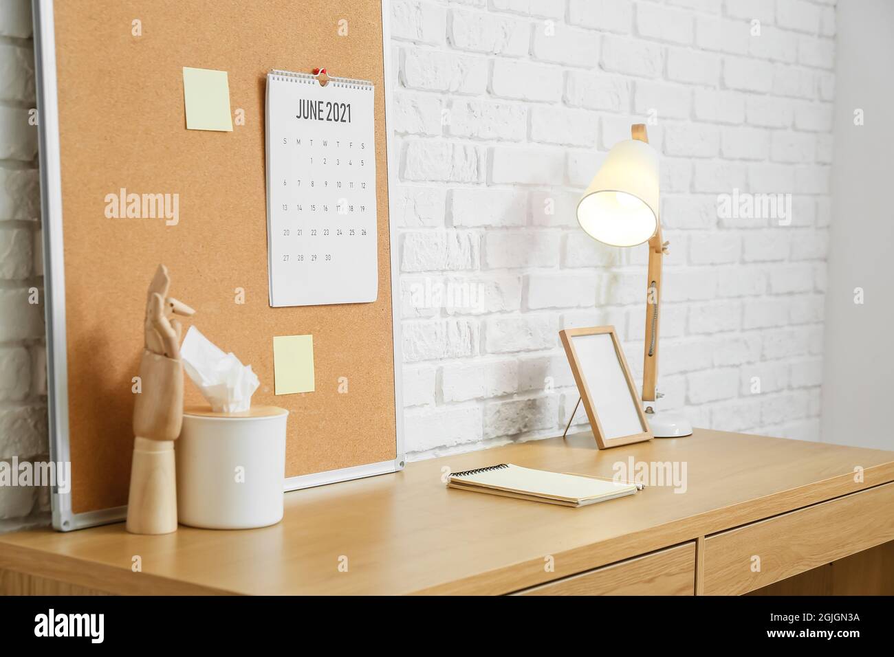 Modern workplace with sticker board near brick wall Stock Photo - Alamy