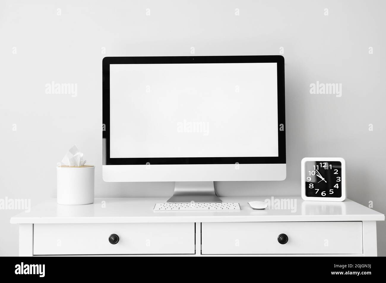 Modern workplace with computer near light wall Stock Photo - Alamy
