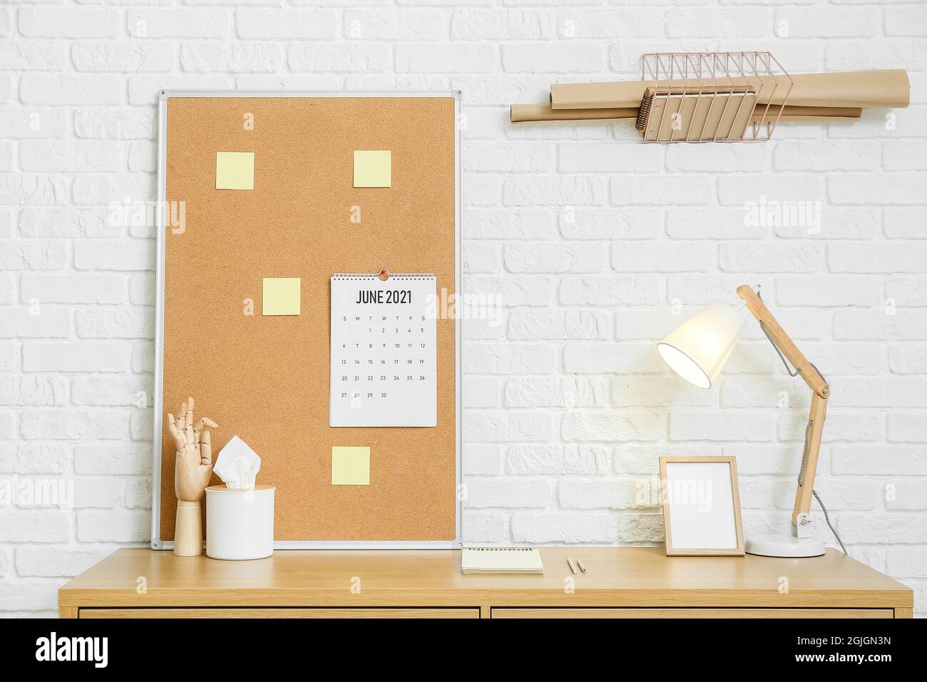 Modern workplace with sticker board near brick wall Stock Photo - Alamy