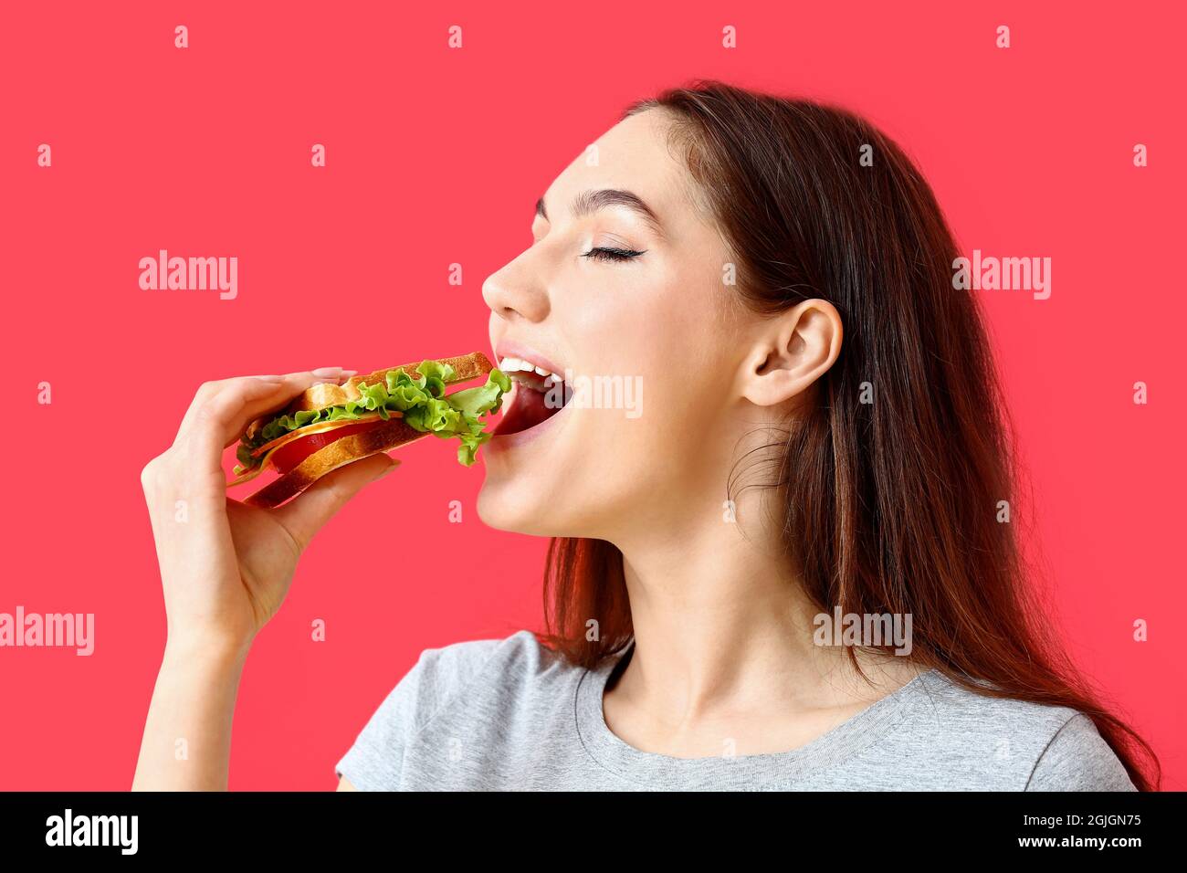 Woman eating bread triangle sandwich hi-res stock photography and ...