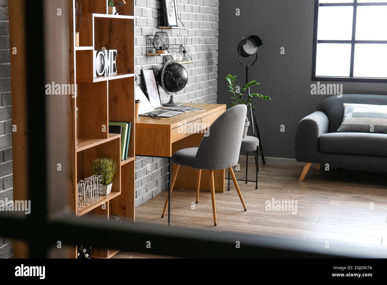 Interior of stylish room with modern workplace Stock Photo - Alamy