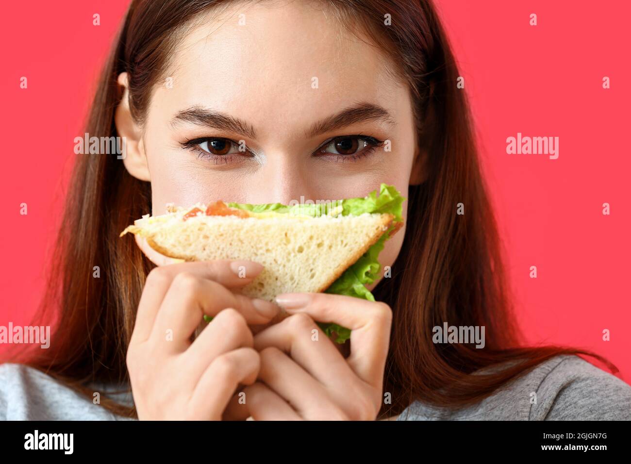 Woman eating bread triangle sandwich hi-res stock photography and ...
