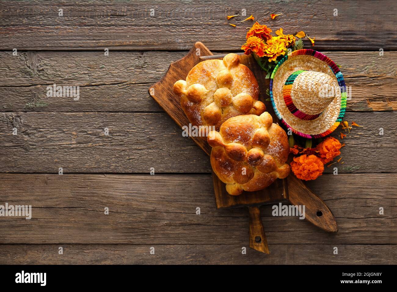 Bread of the dead, sombrero hat and marigold flowers on wooden ...