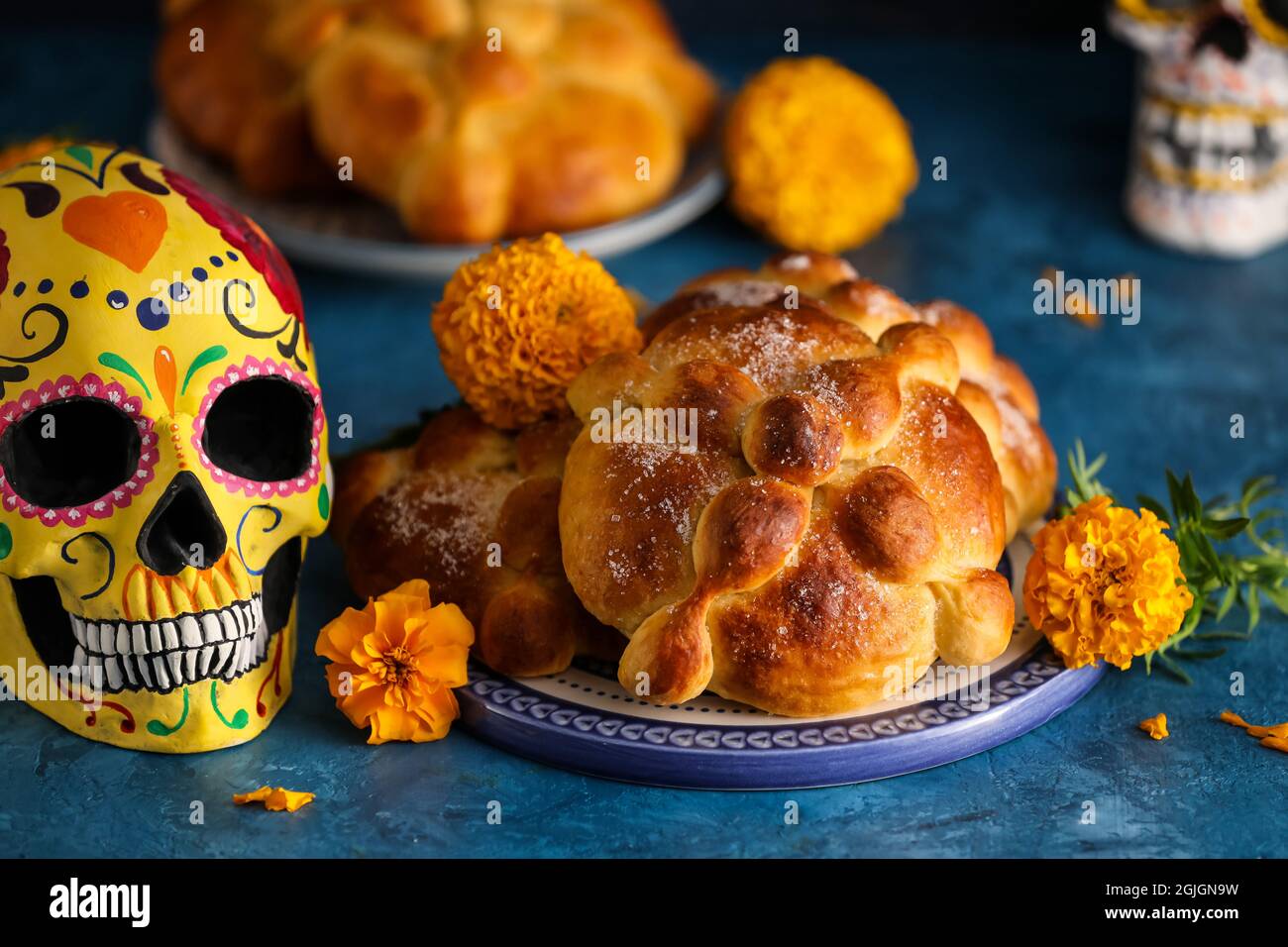 Bread of the dead and painted skull on color background. Celebration of ...