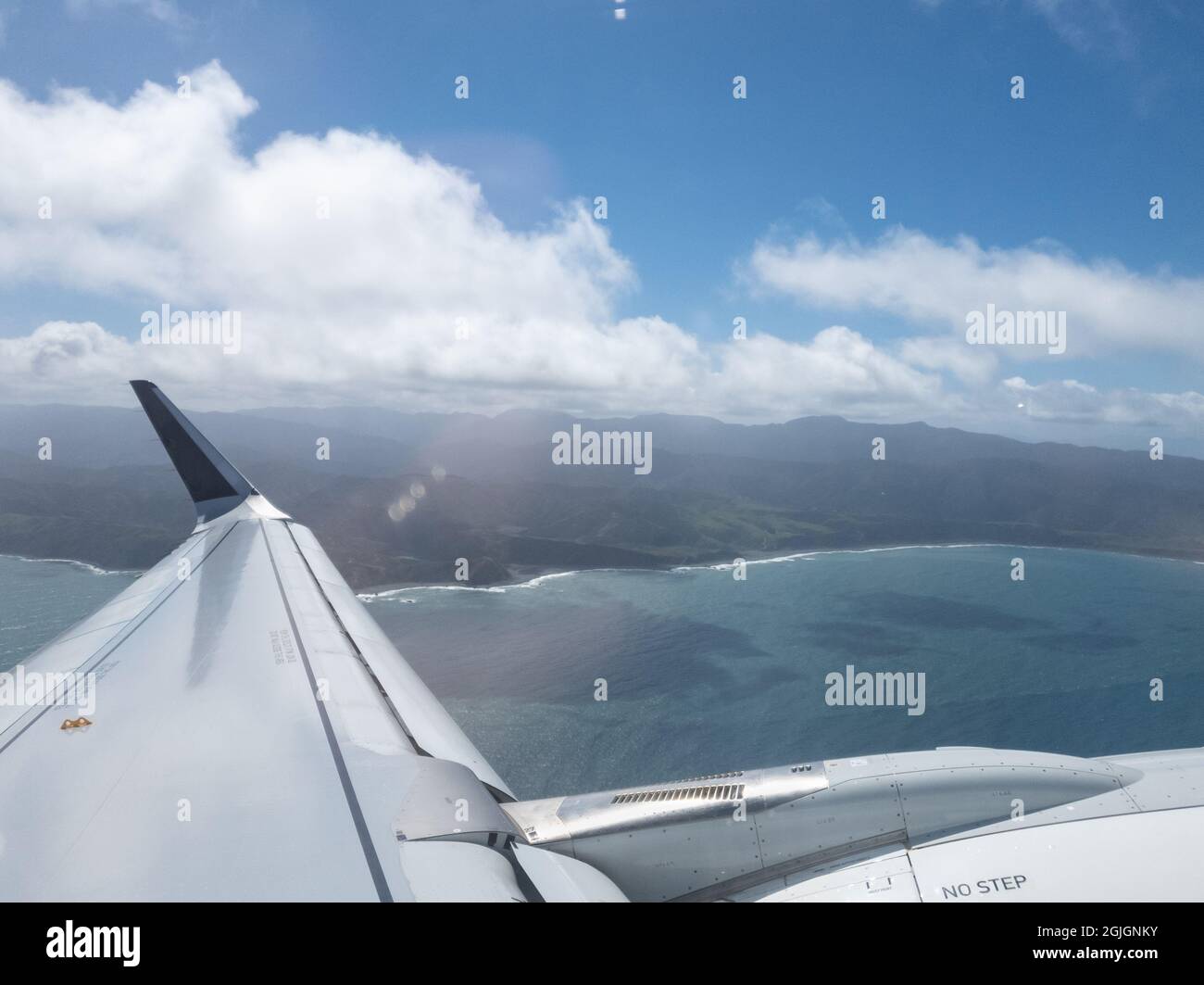 View of the wing of an aircraft flying over New Zealand Stock Photo - Alamy