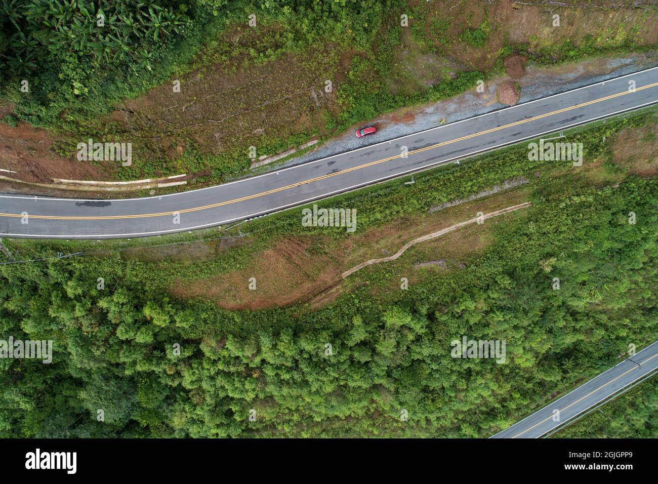 Travel on hilly road in spring aerial view road curve construction up ...