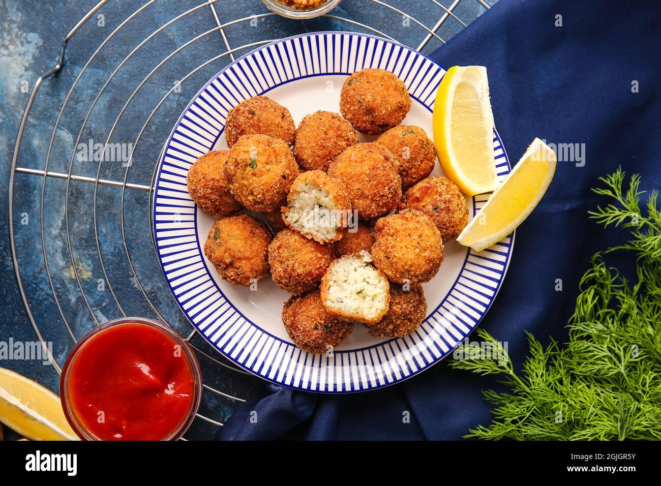 Plate with tasty cod cutlets and sauce on color background Stock Photo ...