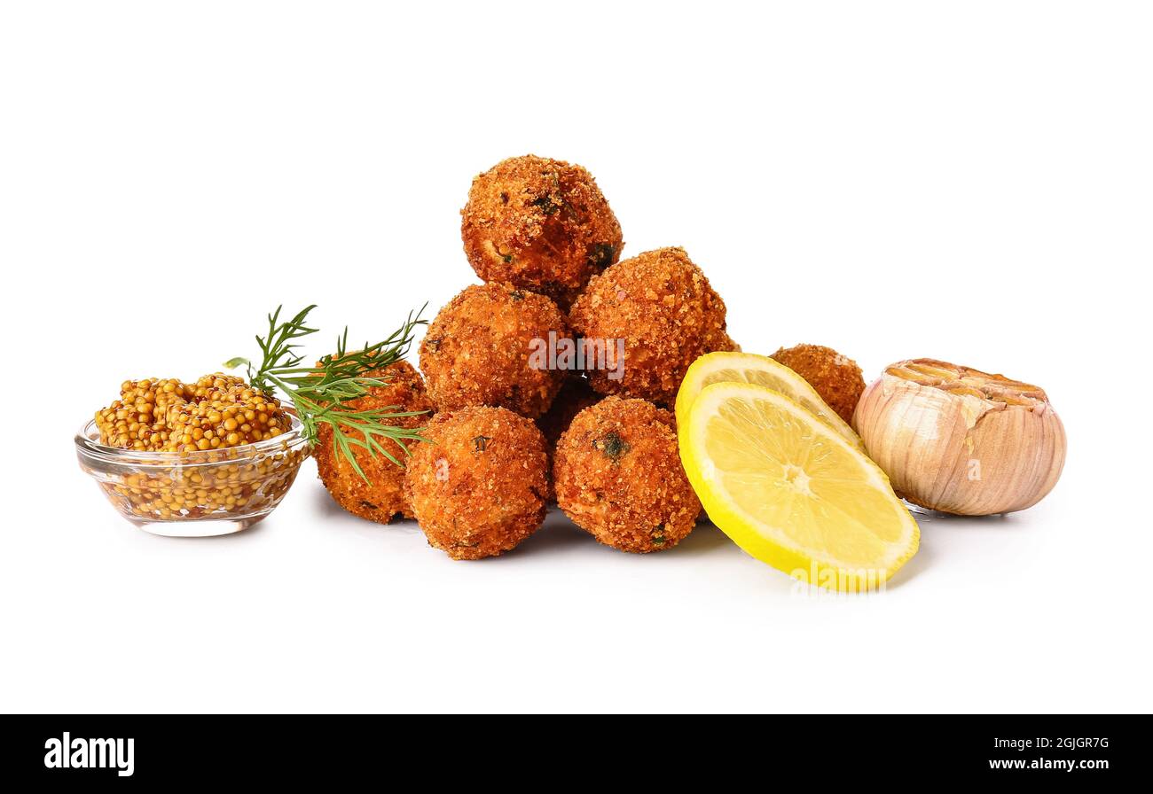 Tasty cod cutlets with lemon and mustard on white background Stock ...