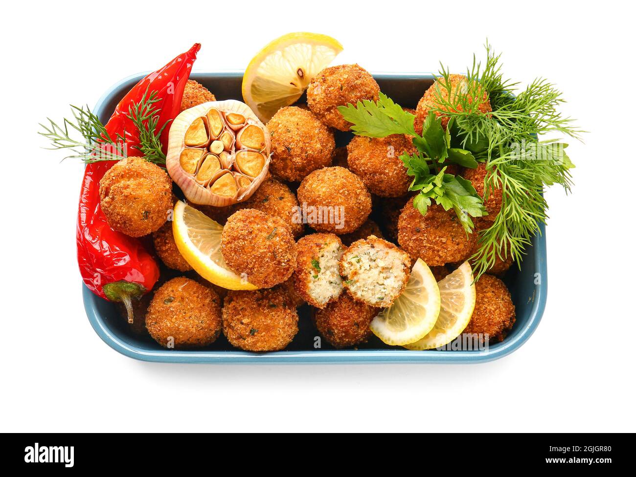 Baking dish with tasty cod cutlets and spices on white background Stock ...
