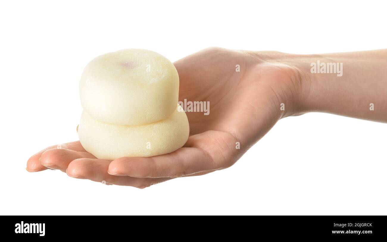 Female hand with tasty Japanese mochi on white background Stock Photo ...