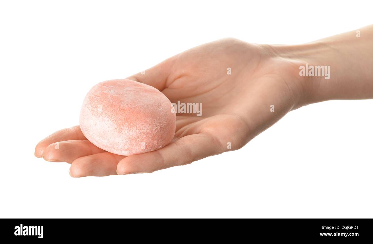 Female hand with tasty Japanese mochi on white background Stock Photo ...