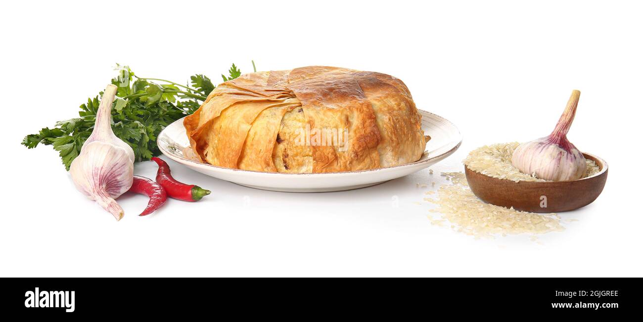 Plate with tasty Shah Pilaf and ingredients on white background Stock ...