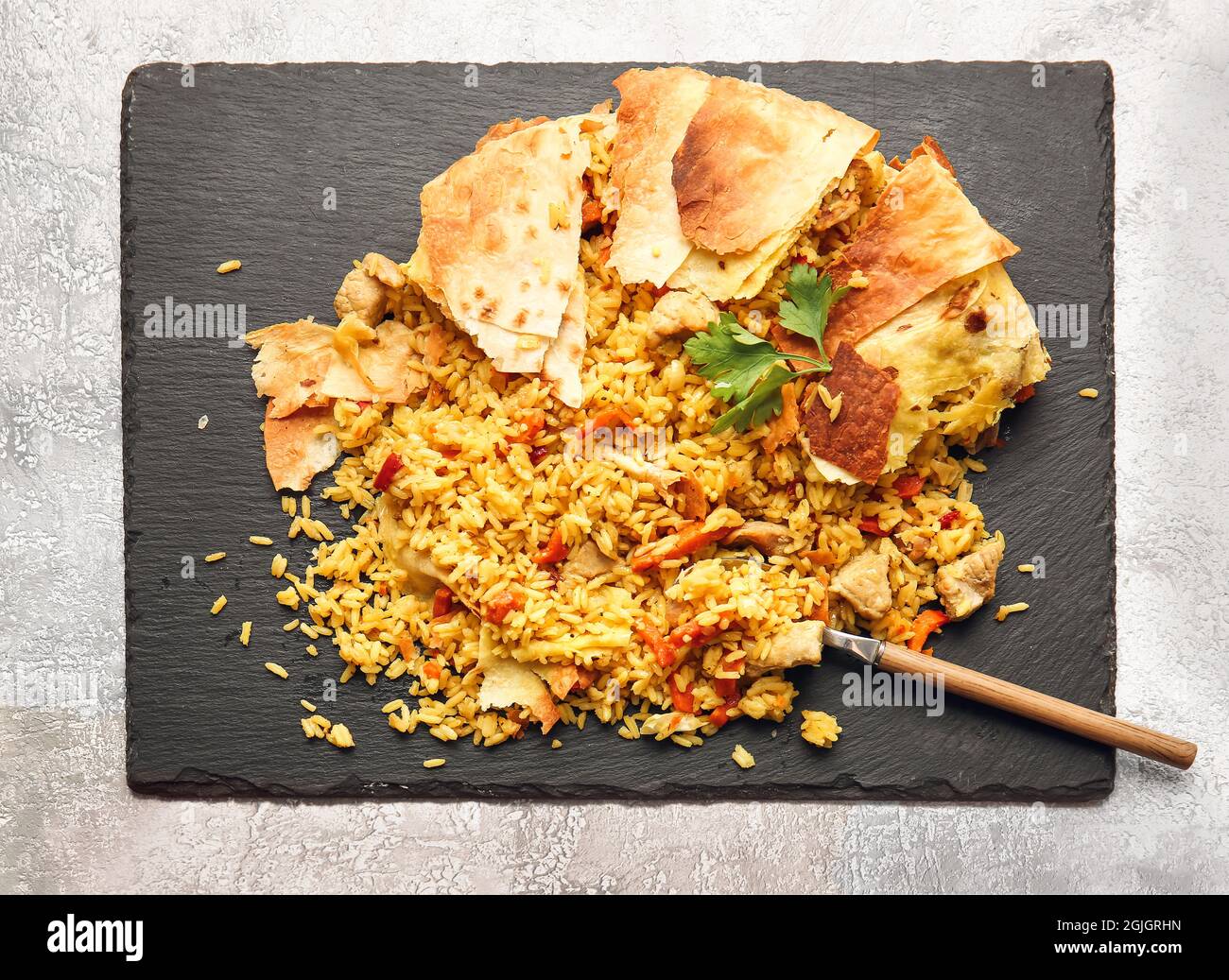 Board with tasty Shah Pilaf on light background Stock Photo - Alamy