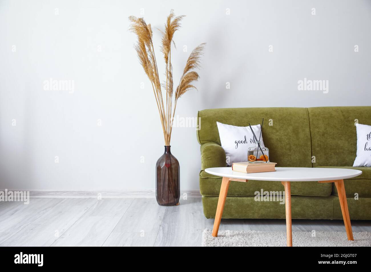 Interior of modern room with table and sofa Stock Photo - Alamy