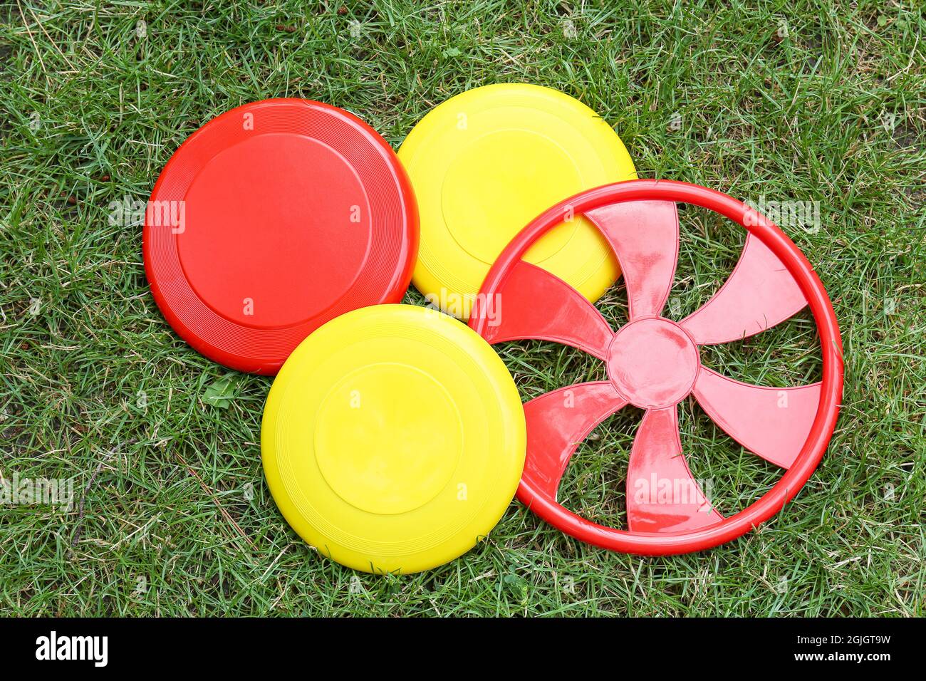 Different frisbee disks on grass outdoors Stock Photo - Alamy