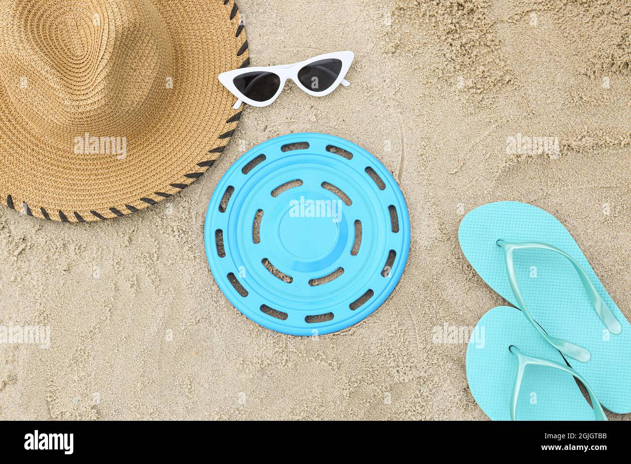 Composition with frisbee disk and beach accessories on sand Stock Photo ...