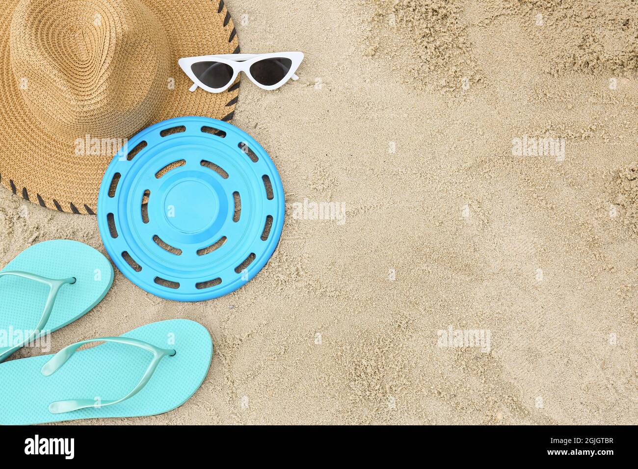 Composition with frisbee disk and beach accessories on sand Stock Photo ...