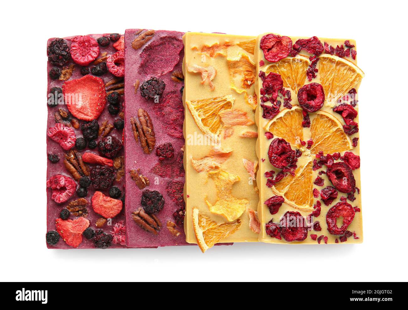 Handmade chocolate bars with fruits, berries and nuts on white ...