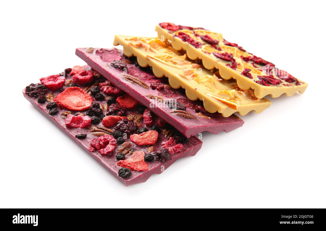 Handmade chocolate bars with fruits, berries and nuts on white ...