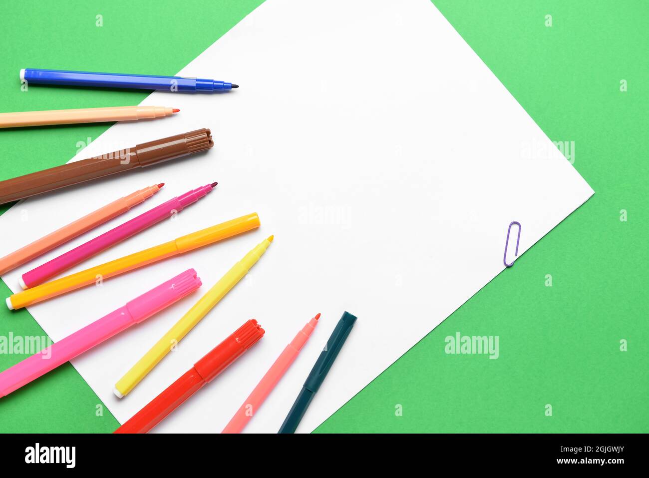 Colorful markers and blank paper sheet on color background Stock Photo ...