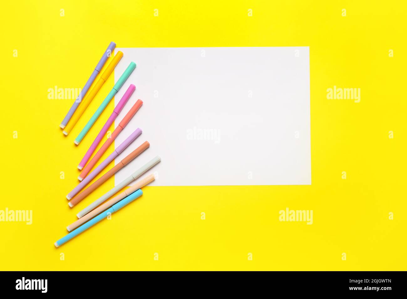 Colorful markers and blank paper sheet on color background Stock Photo ...