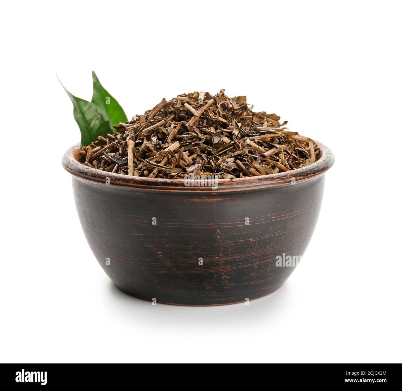 Bowl of dry hojicha green tea on white background Stock Photo - Alamy