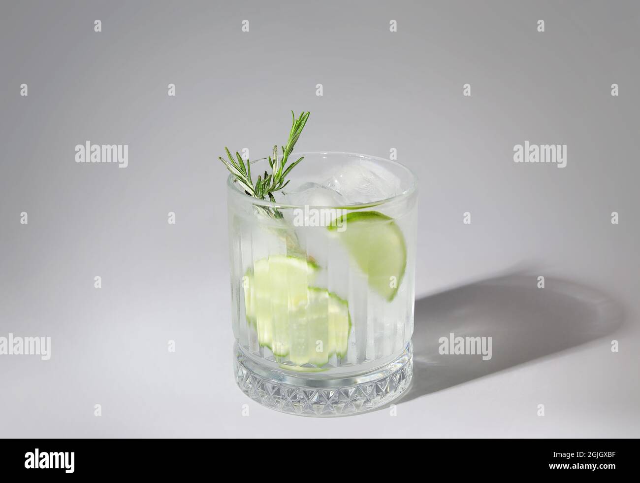 Glass of cold gin and tonic on white background Stock Photo - Alamy