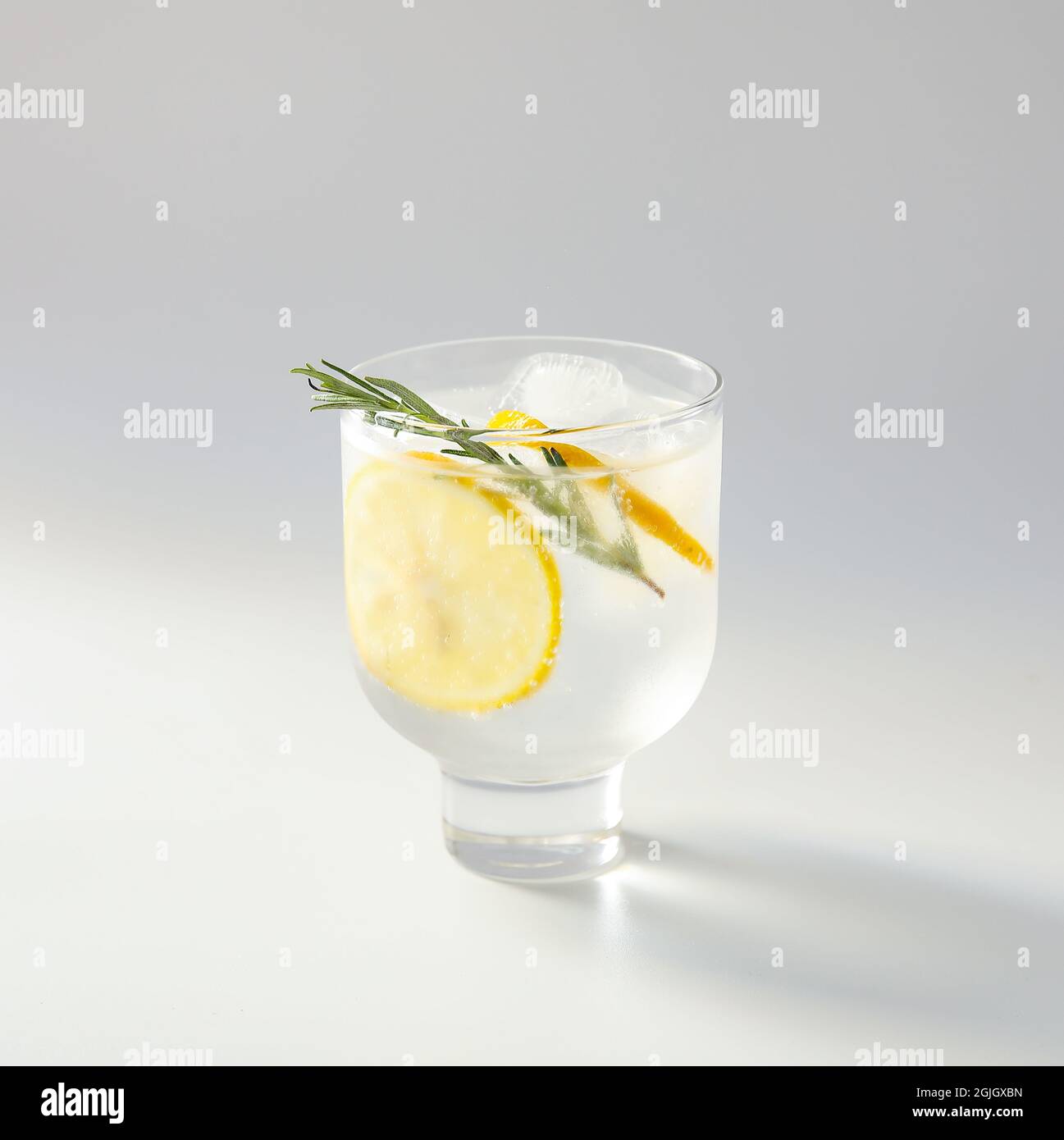 Glass of cold gin and tonic on white background Stock Photo - Alamy