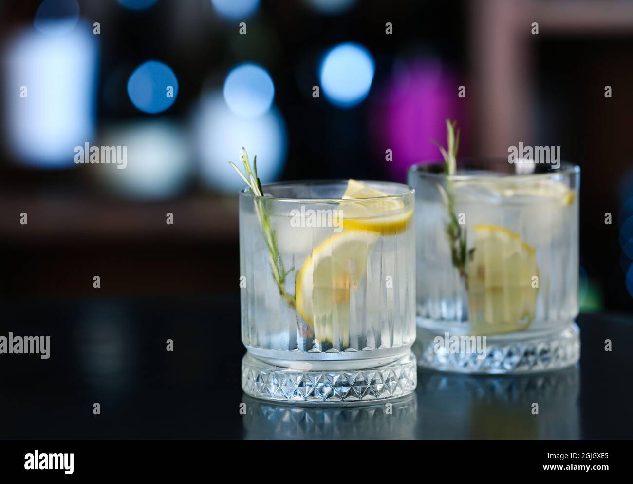 Glasses of cold gin tonic on table in bar Stock Photo - Alamy
