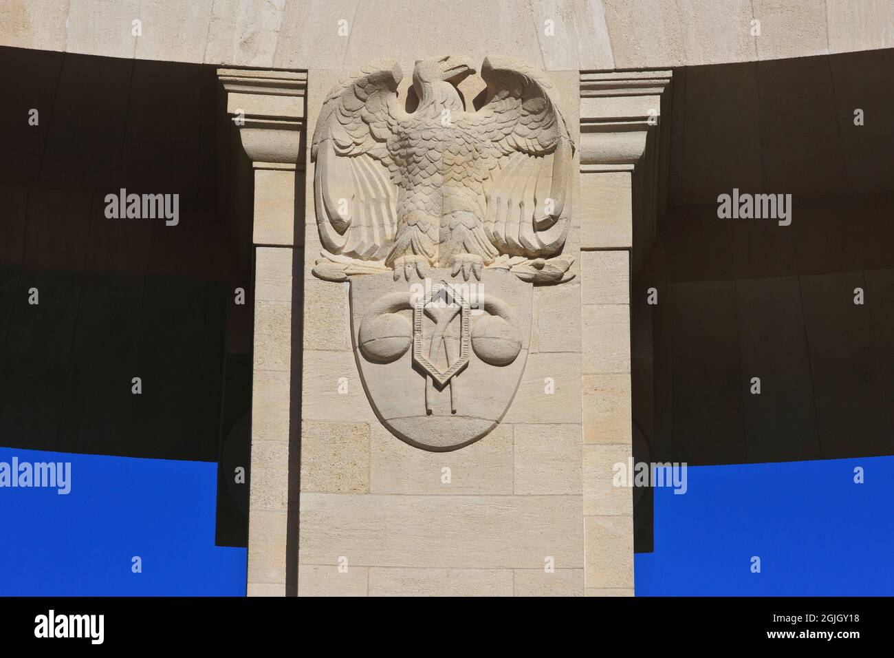 A bald eagle holding the U.S. army chemical corps insignia at the ...